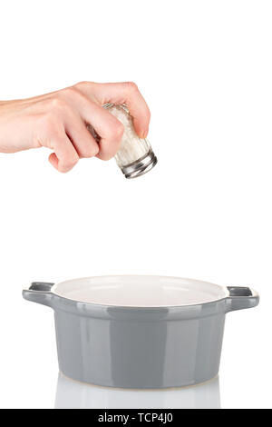 Hand adding salt using salt shaker isolated on white Stock Photo - Alamy