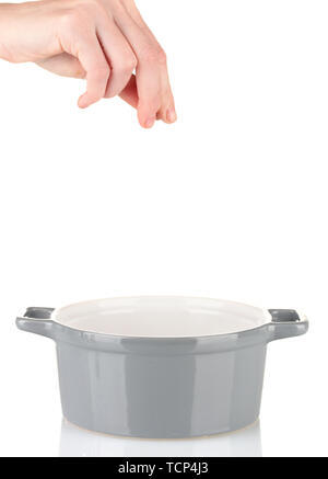 Hand adding salt using salt shaker isolated on white Stock Photo - Alamy