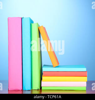 Stack of multicolor books on blue background Stock Photo - Alamy