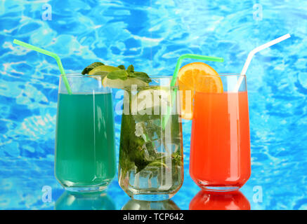 Three cocktails on blue background Stock Photo - Alamy