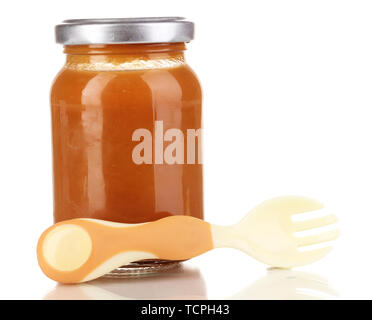 Useful and tasty baby food with beige small spoon on green background ...