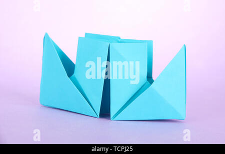 Origami paper steamer on purple background Stock Photo - Alamy