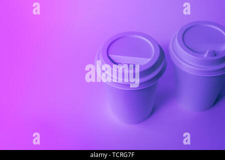 Paper disposable cups in trendy neon light Stock Photo - Alamy