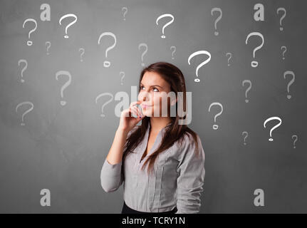 Person with question marks around face Stock Photo - Alamy