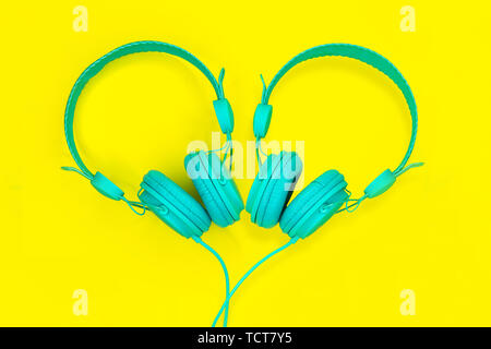 Turquoise or blue headphones or a computer headset on a yellow ...