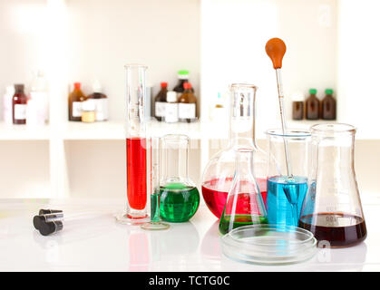 Different laboratory glassware with color liquid on laboratory ...