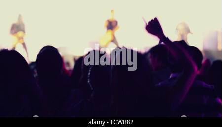 Crowd at concert - Cheering crowd in bright colorful stage lights Stock ...