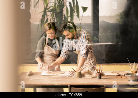 Artisan working in pottery workshop Stock Photo - Alamy