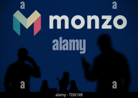 The Monzo bank logo is seen on an LED screen in the background while ...