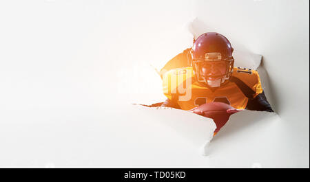 Paper breakthrough hole effect and football player. Mixed media Stock ...
