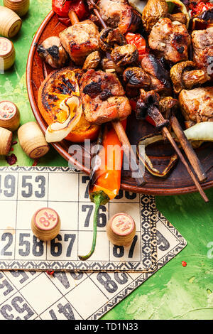 Summer picnic with shashlik and lotto board game.Barbecue and board ...