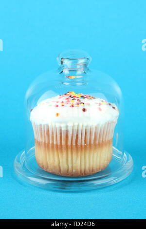 Cupcake on saucer with glass cover, on color background Stock Photo - Alamy
