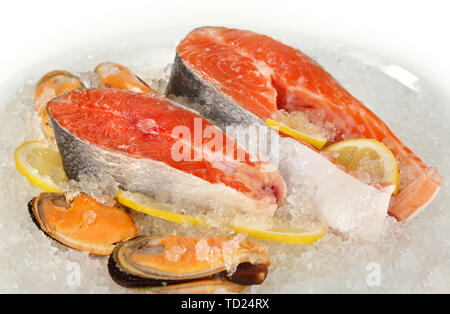 Pieces of red fish on ice in plate isolated on white Stock Photo - Alamy
