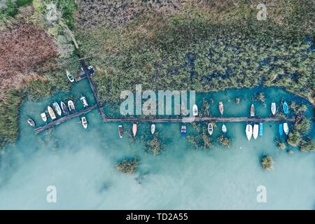 Overhead shot of a little dock at the coast with parked fishing boats ...