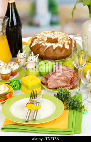 Serving Easter table with tasty dishes on room background Stock Photo ...
