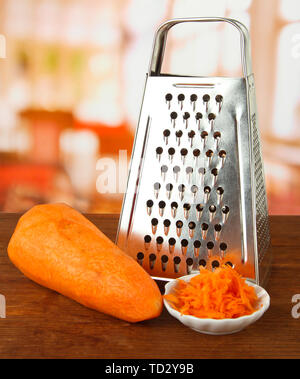 Metal grater and carrot, on bright background Stock Photo - Alamy