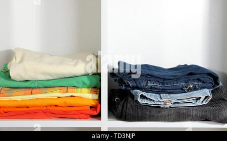 Clothes neatly folded on shelves Stock Photo - Alamy