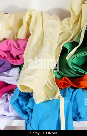 Clothing scattered on shelves Stock Photo - Alamy