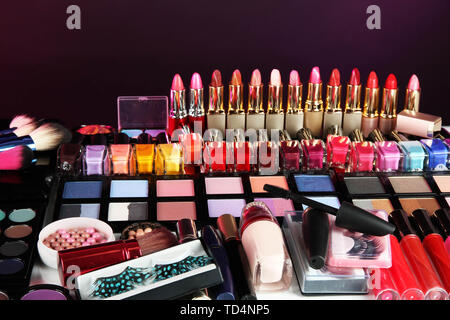Lot of different cosmetics on purple background Stock Photo - Alamy