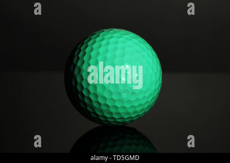 Golf ball on grey background Stock Photo - Alamy