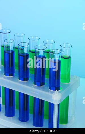 Identical test tubes on blue background Stock Photo - Alamy