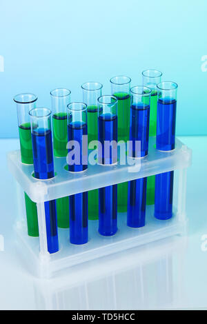 Identical test tubes on blue background Stock Photo - Alamy