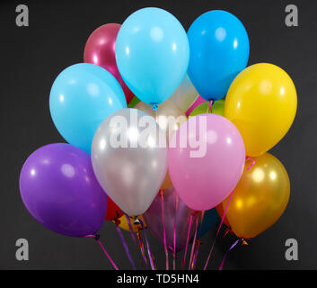 Many bright balloons isolated on black Stock Photo - Alamy