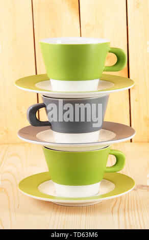 Three cups on a wooden background in different positions Stock Photo ...