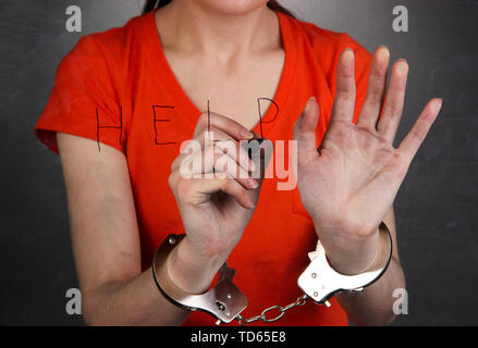 Prisoner in handcuffs behind glass in soundproof room Stock Photo - Alamy