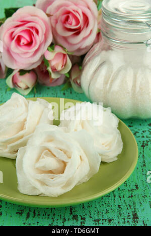 Sugar roses and natural roses, glass jar with sugar, on color ...