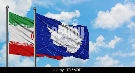 Antarctica and Iran flag waving in the wind against white cloudy blue ...