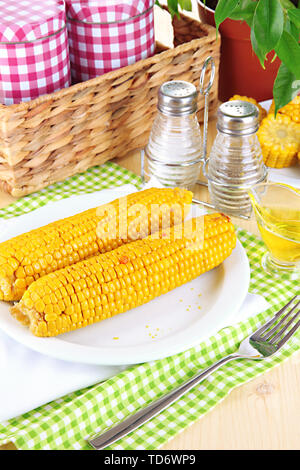 Flavored boiled corn on plate on wooden table close-up Stock Photo - Alamy
