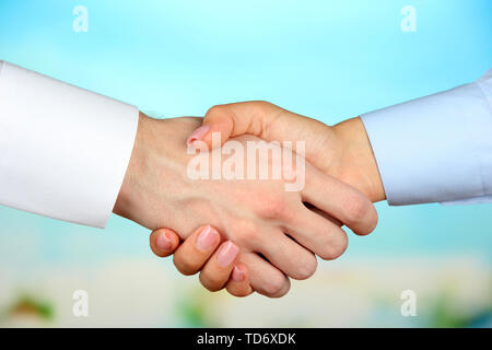 Business handshake on bright background Stock Photo - Alamy