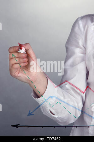 Woman paints graphic on glass on grey background Stock Photo - Alamy