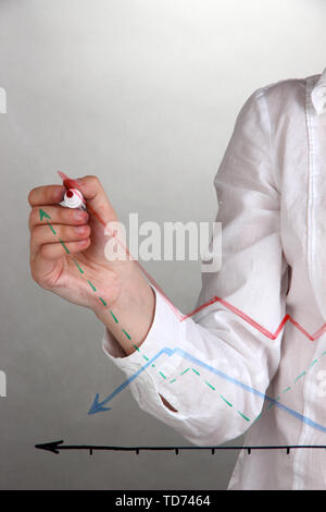 Woman paints graphic on glass on grey background Stock Photo - Alamy