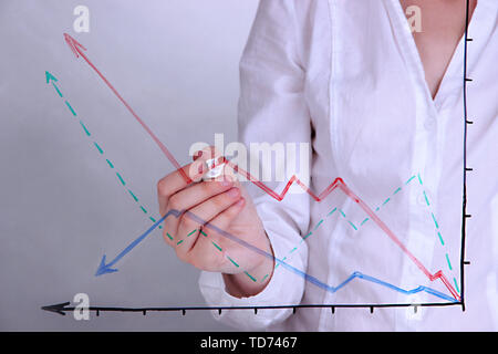 Woman paints graphic on glass on grey background Stock Photo - Alamy