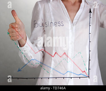 Woman paints graphic on glass on grey background Stock Photo - Alamy
