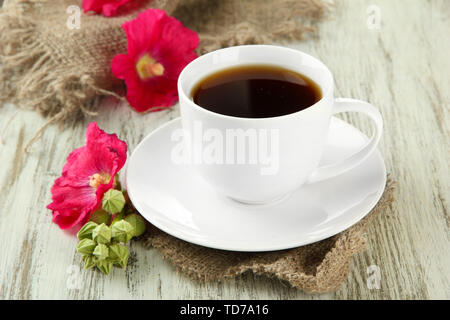 Cup of coffee and pink mallow flowers on wooden background Stock Photo ...