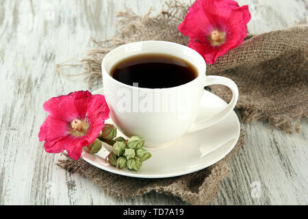 Cup of coffee and pink mallow flowers on wooden background Stock Photo ...