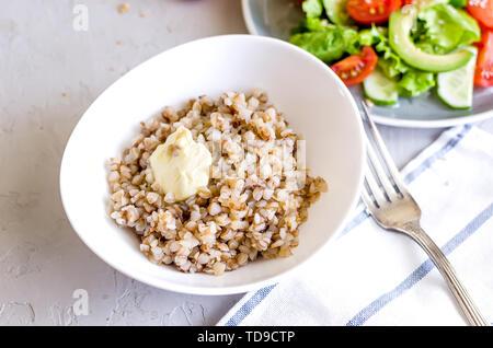 hot Buckwheat porridge with melting butter in plate andHealthy ...