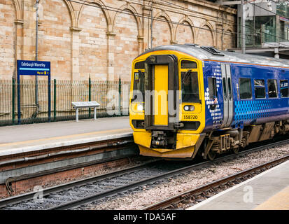 A Scotrail train at a platform at Edinburgh Waverley Train Station ...