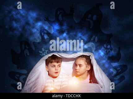 scared brother and sister in blanket watching tv together isolated on ...