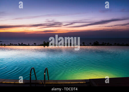 Infinity pool above seaside at dusk luxury vacation abstract Stock ...