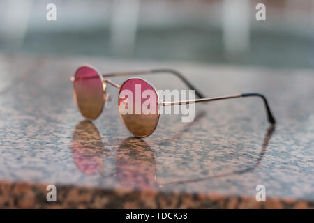 Round hipster sunglasses on pink background. Fashion accessory for ...