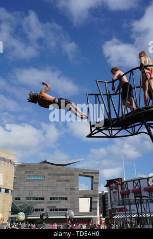 Boy jumping from platform in wellington Stock Photo - Alamy