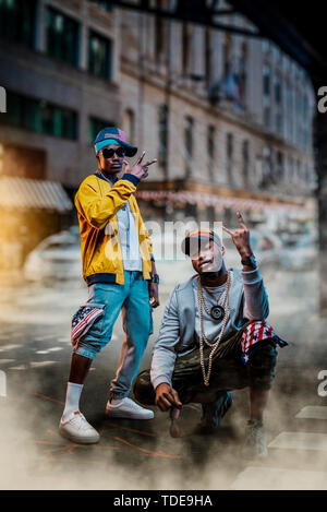 Black rappers in caps on stage with spotlights Stock Photo - Alamy