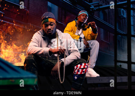 Two black rappers in caps, artists on stage Stock Photo - Alamy