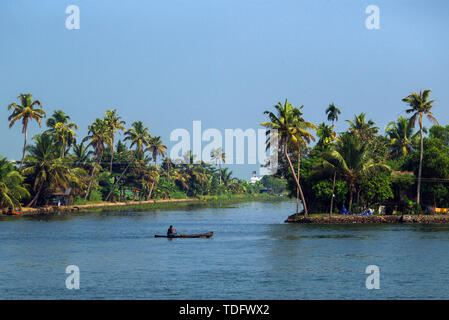 Locals ride boats along the backwaters of Alleppey in Kerala, India ...