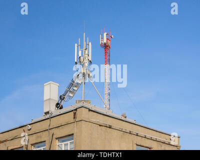 Telecommunication base stations network repeaters on the roof of building. The cellular ...