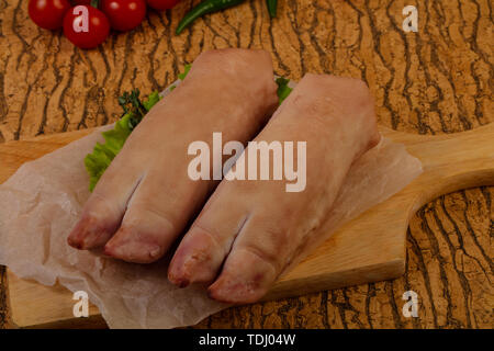 Raw pig's hoof ower wooden background Stock Photo - Alamy
